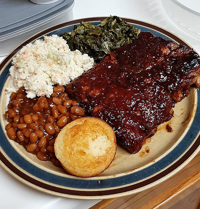 Those baby back ribs with their glossy sauce aren't just falling off the bone - they're practically jumping onto your fork with delicious intention.