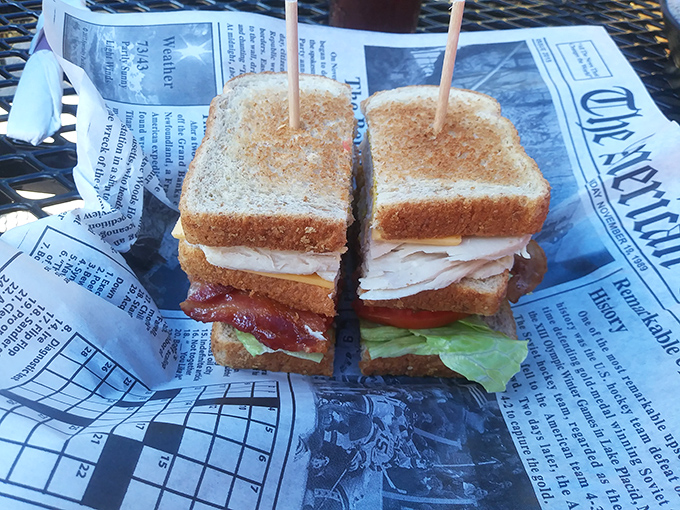 A classic BLT served on newspaper&mdash;because good diners know presentation isn't about fancy plates, it's about food so honest it can tell its own story.