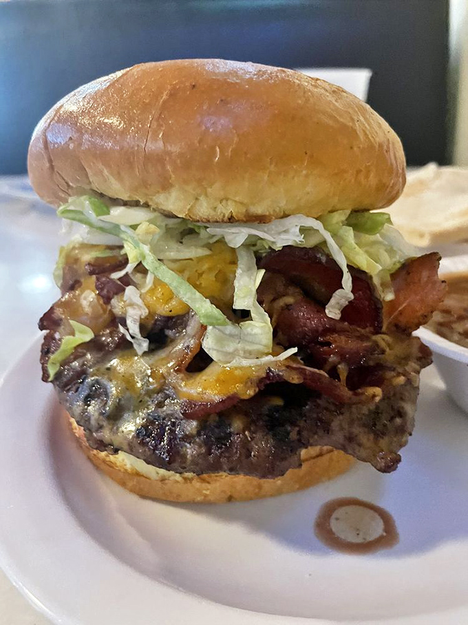 This isn't just a burger – it's an architectural achievement. Layers of bacon, cheese, and fresh toppings create a towering monument to indulgence.