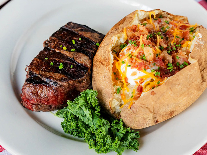 The loaded baked potato arrives looking like it's wearing its Sunday best, while the steak maintains a dignified medium-rare perfection that speaks of careful attention.