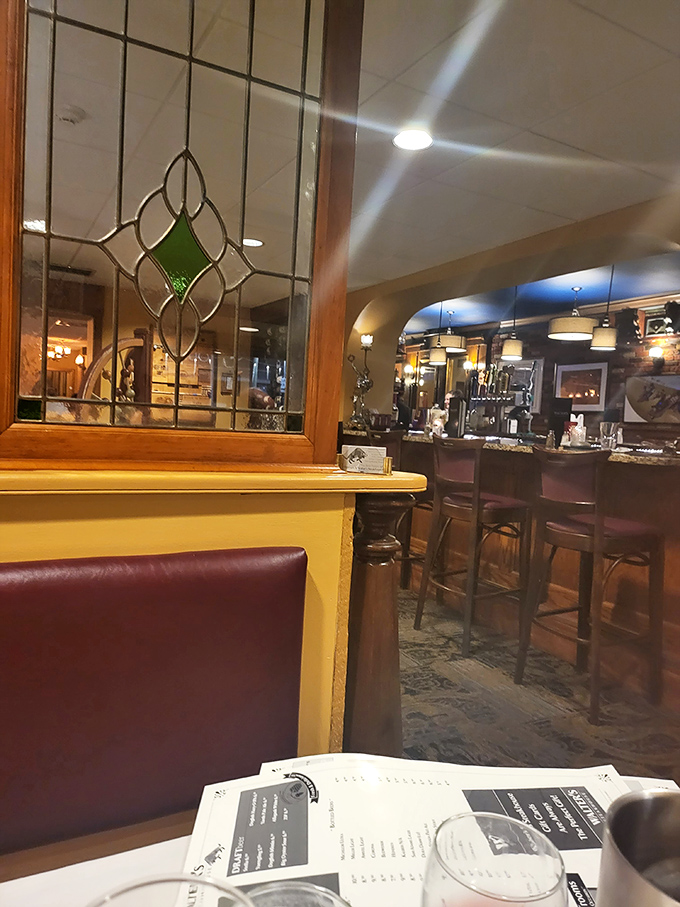 The bar area peeks through leaded glass, promising old-school cocktails mixed by people who understand proper proportions.