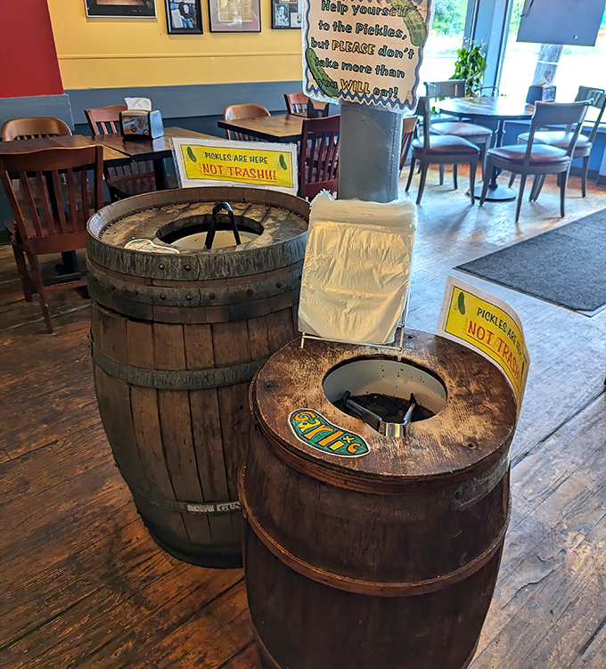 Pickle barrels standing proud like sentinels of sourness. The signs warn "not trash" because treasures this tasty need protection.