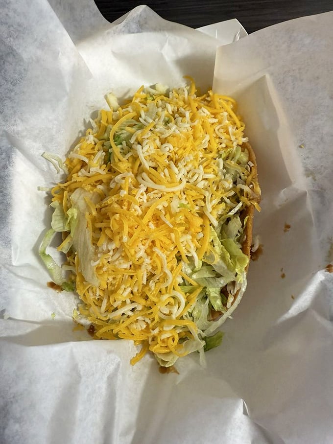 A bean tostada crowned with lettuce and cheese, proving vegetarian options can steal the show too.