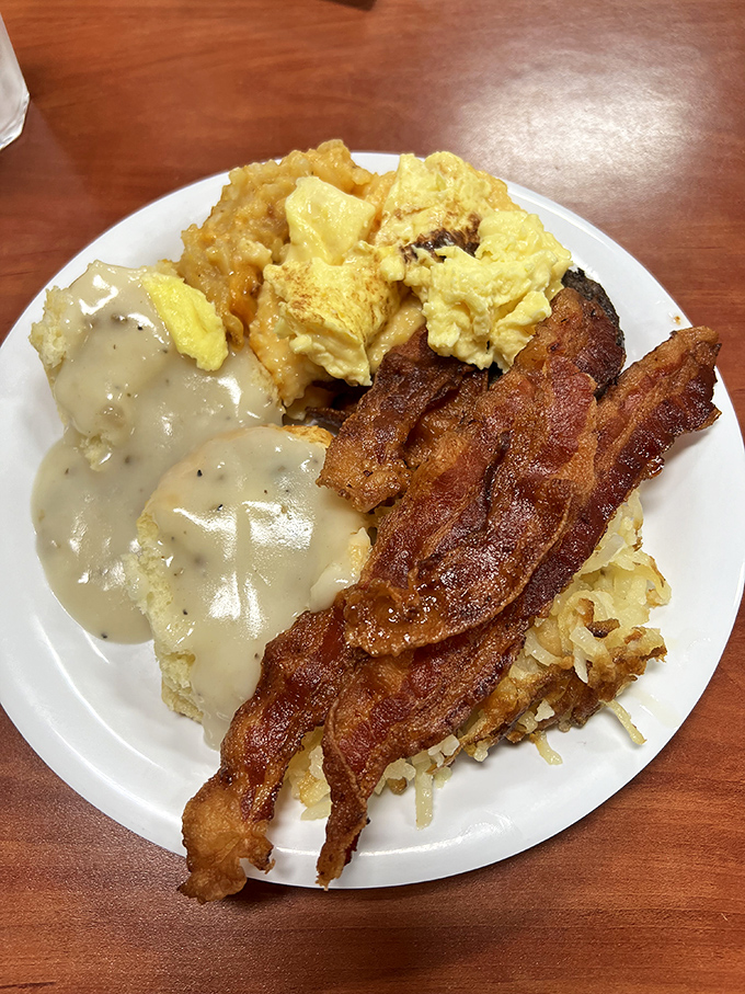 Biscuits smothered in peppery gravy alongside crispy bacon and scrambled eggs &ndash; the breakfast trinity that's converted more morning skeptics than coffee itself.