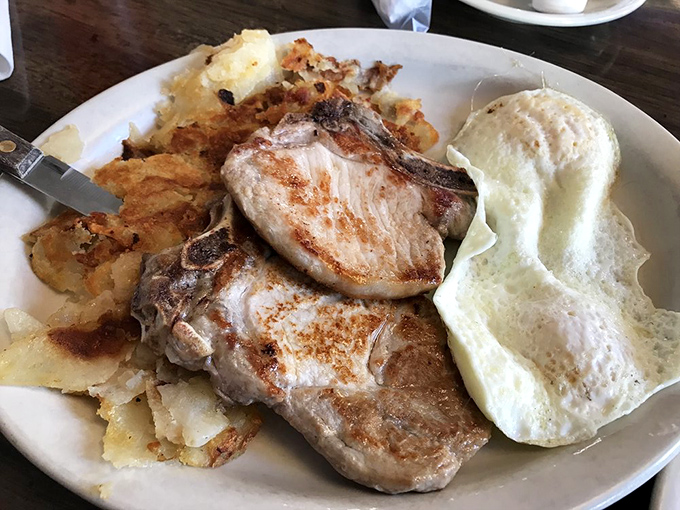 Pork chops thick enough to use as bookends, served with eggs that know their supporting role perfectly.