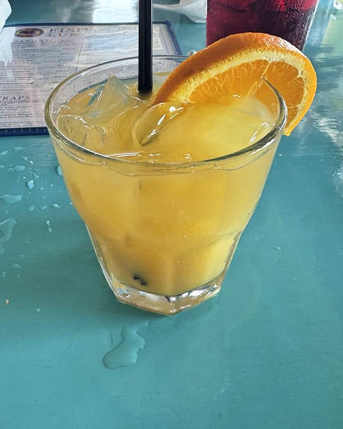 This sunshine-colored cocktail looks like summer in a glass. The orange garnish isn't just decoration&mdash;it's a promise of citrusy refreshment.