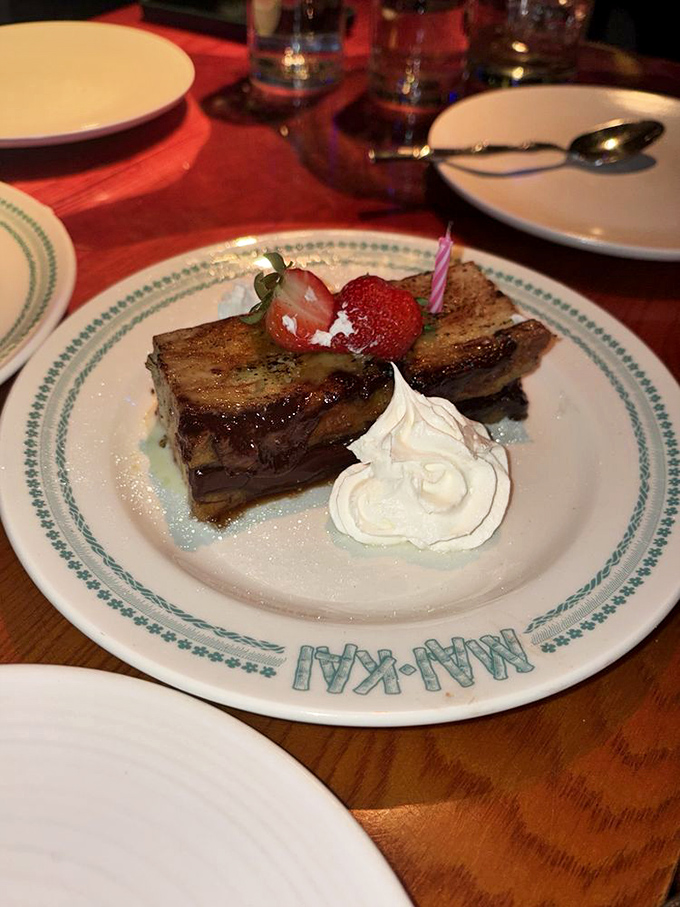 This isn't just dessert&mdash;it's bread pudding that's having its glamour shot moment, complete with whipped cream, fresh berries, and a tiny candle celebration.