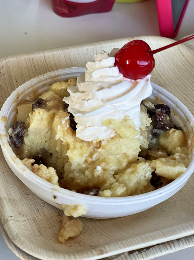 Bread pudding topped with whipped cream and cherry creates the perfect sweet ending to paradise.