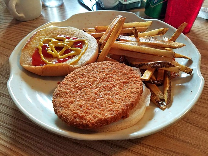 A perfectly breaded sandwich with hand-cut fries. Simple food done right – the kind that makes you question why anyone needs fancy restaurants.