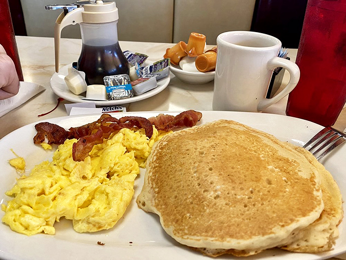 The breakfast that launched a thousand productive days&mdash;golden pancakes alongside perfectly scrambled eggs and bacon that shatters like glass.