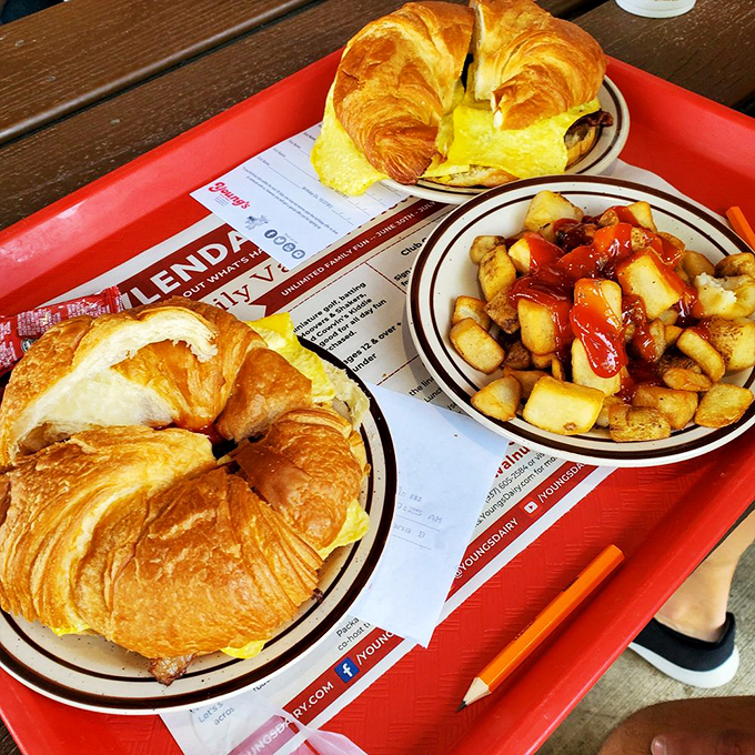 Breakfast that means business: golden croissant sandwiches and home fries swimming in ketchup. The pencil is for listing all the ice cream flavors you'll try later.