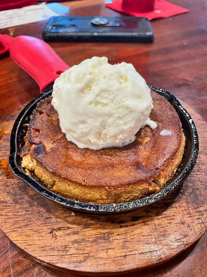 The cast iron cookie arrives sizzling with a crown of vanilla ice cream melting into warm, gooey perfection. Spoons up, folks&mdash;this dessert waits for no one.