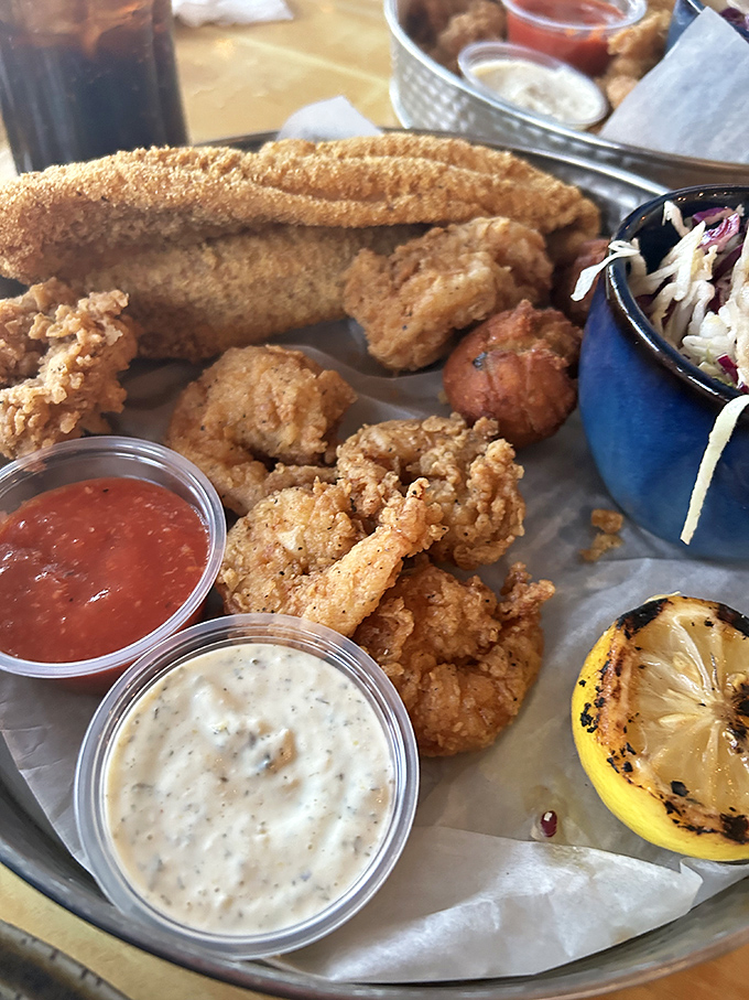 Fried seafood perfection that makes you wonder if calories consumed while coastal dining actually count. That remoulade deserves its own fan club.