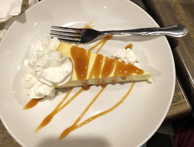 Cheesecake with caramel drizzle &ndash; proof that even after a seafood feast, there's always that separate dessert compartment waiting to be filled.