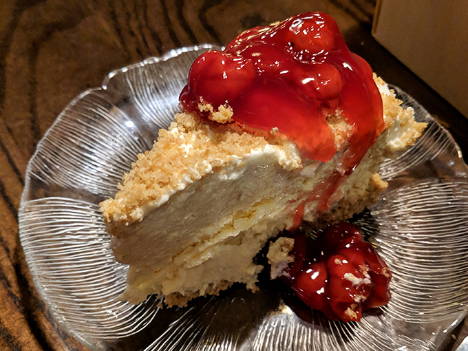 Cheesecake crowned with ruby-red cherry topping that makes you wonder why anyone bothers with chocolate. The kind of dessert that silences conversation.