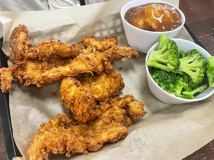 Chicken tenders that have clearly been raised right, with manners enough to share the stage with broccoli and dipping sauce.