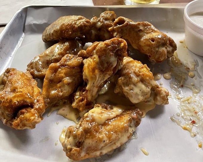 These wings, glistening with sauce, aren't just food&mdash;they're a reason to schedule your next visit before you've even finished this one.