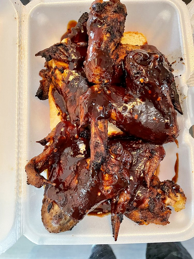 BBQ chicken wings glistening with sauce so good you'll be contemplating whether licking the container is socially acceptable.