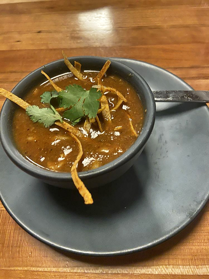 This isn't just soup&mdash;it's a spicy, soul-warming hug in a bowl, complete with crispy tortilla strips for texture.