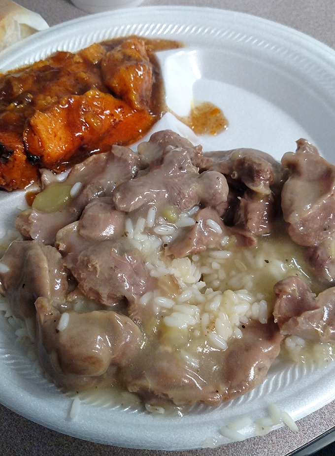 Chicken gizzards and rice swimming in gravy alongside candied yams&mdash;proof that true culinary wisdom often involves transforming the humble into the extraordinary.