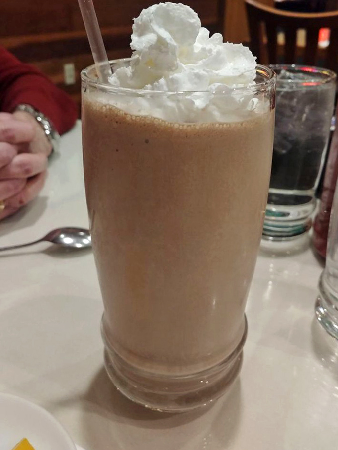 A chocolate milkshake topped with whipped cream that doesn't care what time of day it is—it's always milkshake o'clock somewhere.