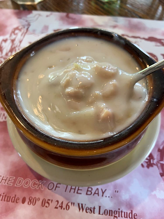 The clam chowder close-up reveals what comfort food should be: rich, hearty, and worth every calorie-laden spoonful.