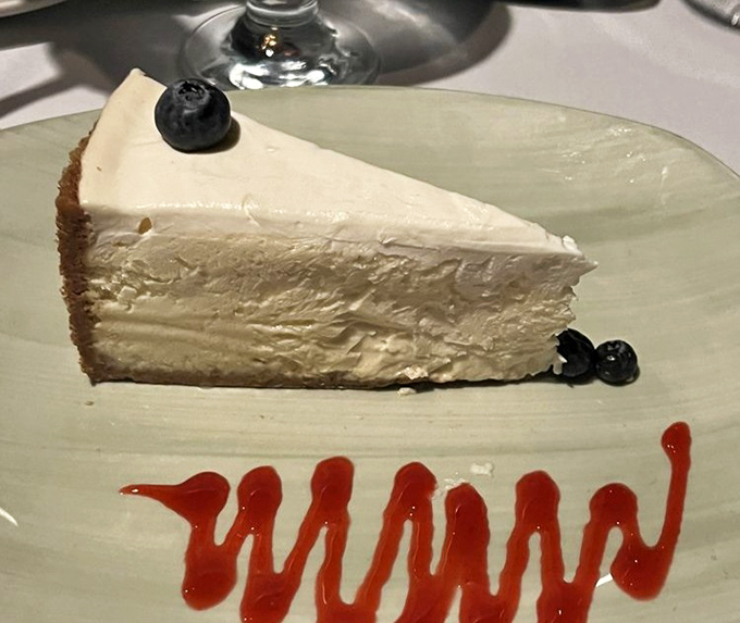 A slice of cheesecake that understands the importance of simplicity&mdash;creamy, rich, and adorned with just enough berries to count as "fruit."