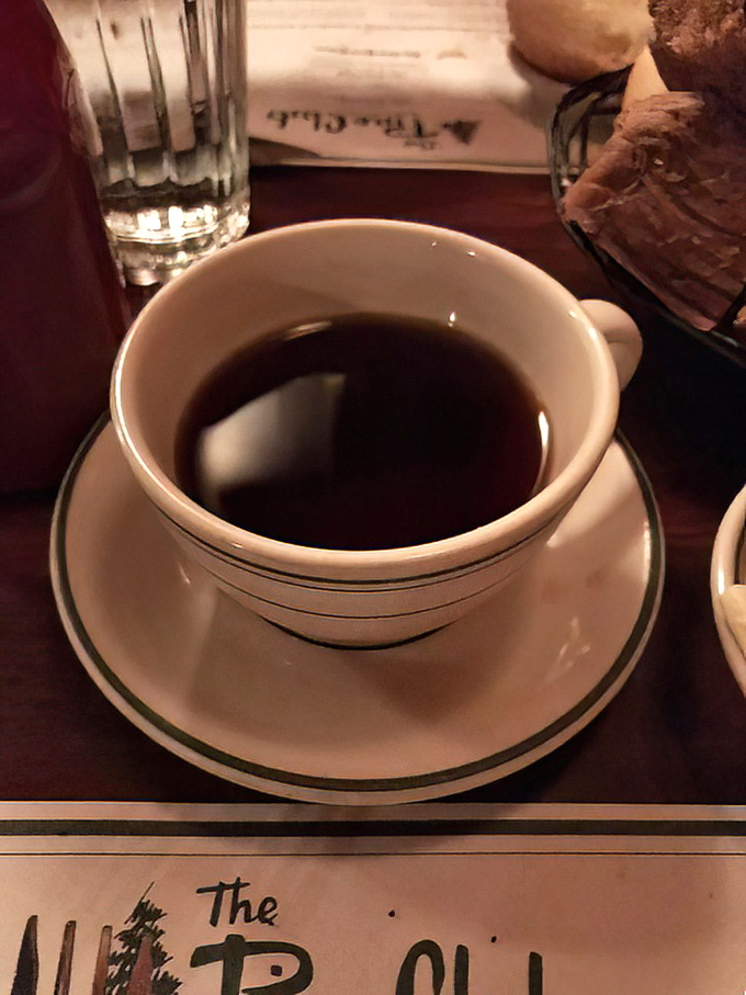 A cup of strong coffee in a classic white mug&mdash;the perfect companion for contemplating whether you have room for one more stewed tomato.