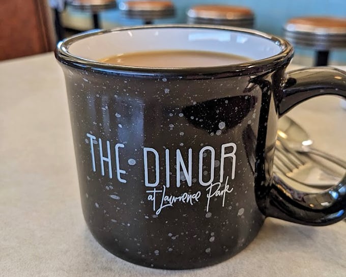 That speckled mug isn't just holding coffee&mdash;it's cradling liquid motivation in ceramic form, proudly displaying its "DINOR" heritage.