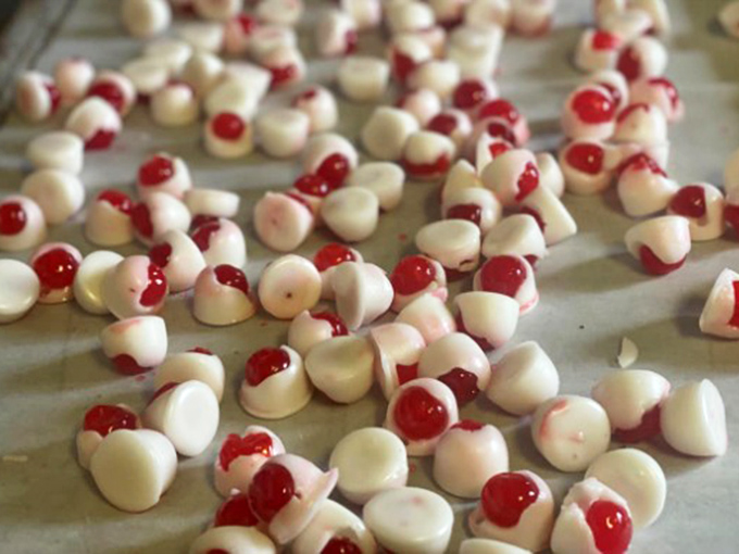 White chocolate drops with cherry centers – like tiny snow-capped volcanoes with sweet, molten cores waiting to erupt with flavor.