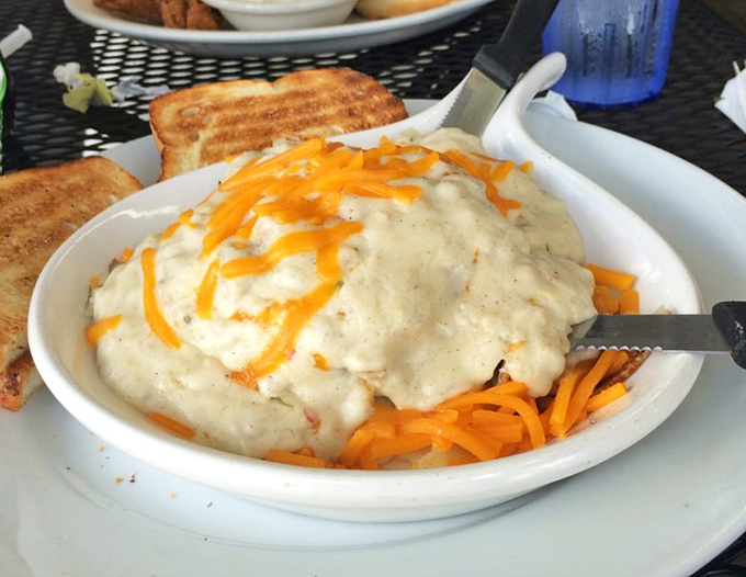 This isn't just country fried steak&mdash;it's a comfort food monument topped with shredded cheddar that melts into the gravy like sunshine on a Florida morning.