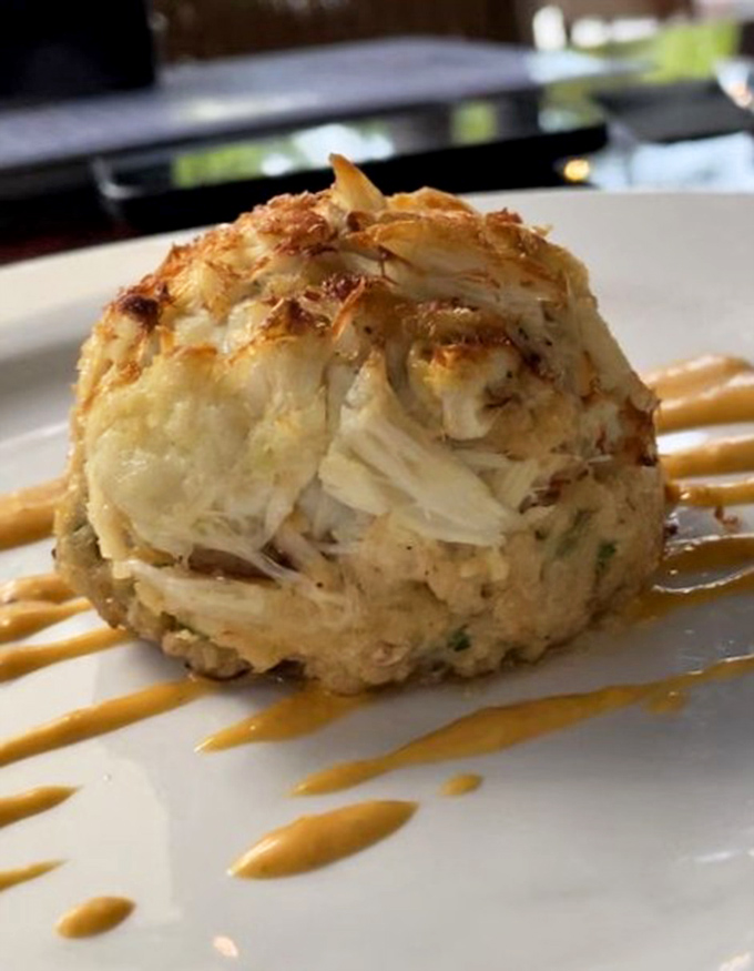 Not just any crab cake—a masterpiece of lump crabmeat that makes you question all other crab cakes you've ever encountered.