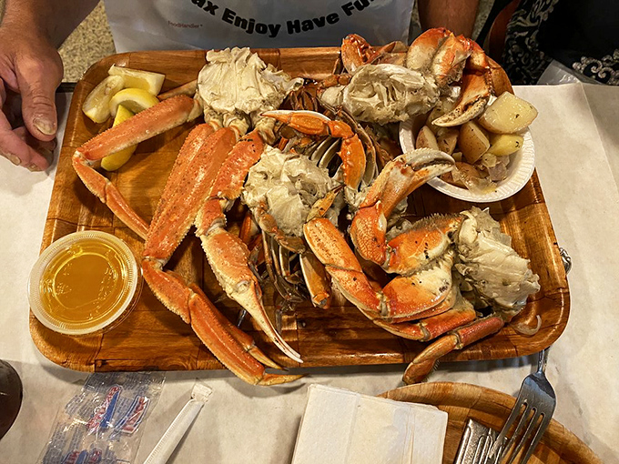 Snow crab legs arranged like a wooden seafood sundial, marking the time you'll spend in buttery, finger-licking bliss.