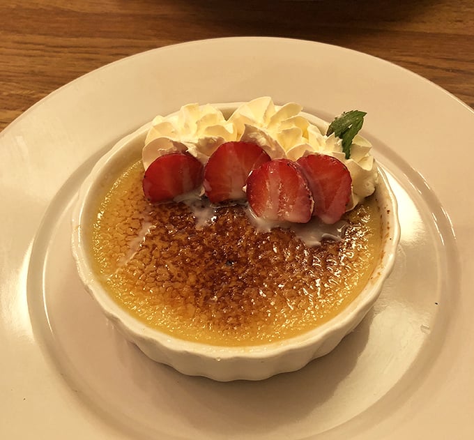 The perfect cr&egrave;me br&ucirc;l&eacute;e sports a crackling sugar crust that shatters with satisfying resistance, revealing silky custard beneath&mdash;dessert engineering at its finest.