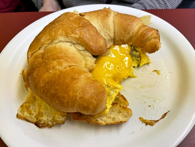 That magical moment when yolk meets croissant &ndash; breakfast sandwich perfection achieved.