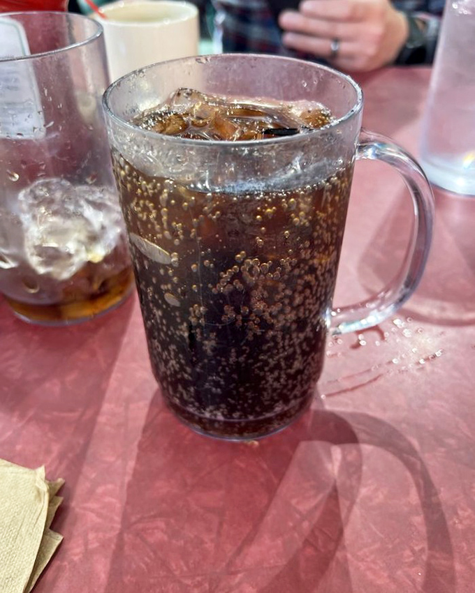 Even the soda comes in those classic diner mugs that somehow make everything taste like childhood summers and infinite possibilities.