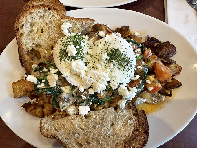 Eggs Florentine elevated with feta cheese and perfectly seasoned potatoes&mdash;breakfast architecture that's both beautiful and delicious.