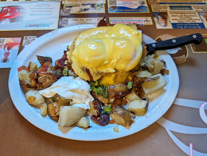 This eggs benedict isn't messing around. Hollandaise cascading over English muffins like a yellow waterfall of breakfast bliss.