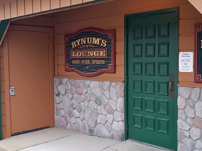 "Bynum's Lounge" promises libations to complement your meal. That green door might as well be a portal to steak paradise.