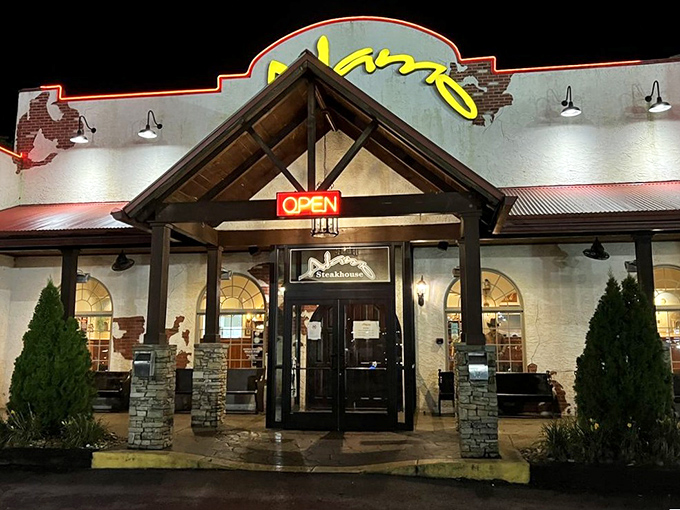 As night falls, the Alamo's illuminated entrance beckons like a lighthouse for the hungry, promising meaty treasures within.