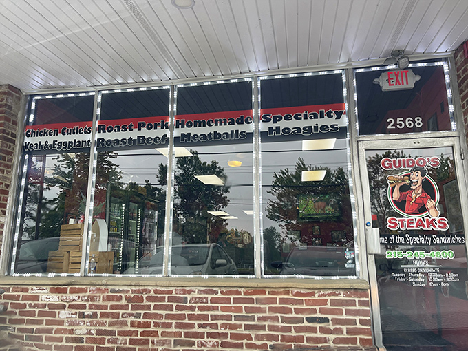 Window signage that doubles as a menu preview. Each word ("Roast Pork," "Hoagies") is like a siren call to the hungry.