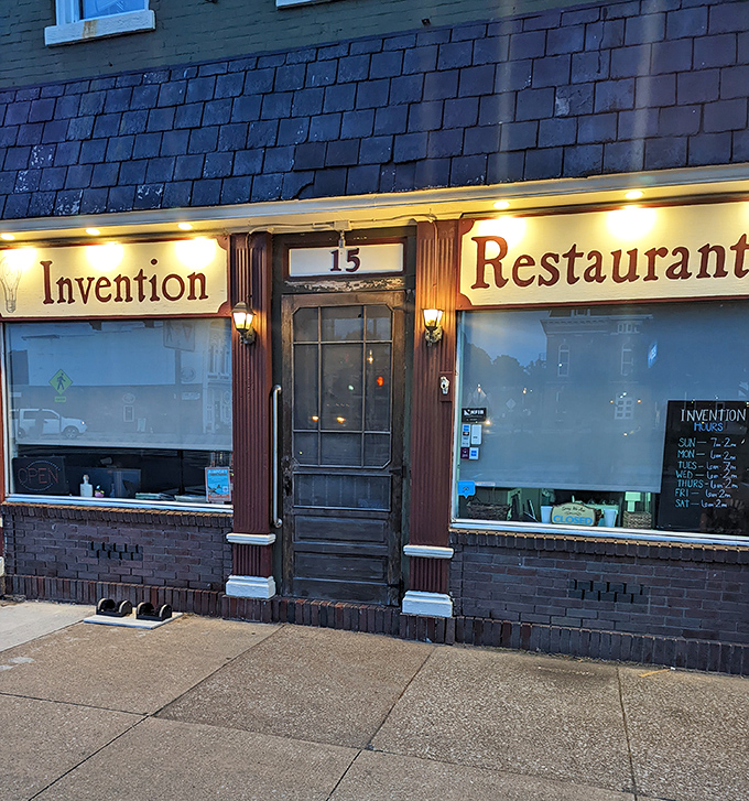 As evening falls, Invention Restaurant's warm glow beckons hungry travelers like a lighthouse for those lost in a sea of chain restaurants.