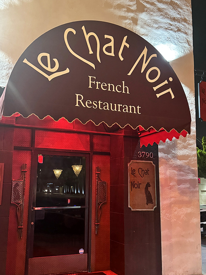 By night, the entrance glows like a portal to Paris. The only passport required is an appetite for the extraordinary.