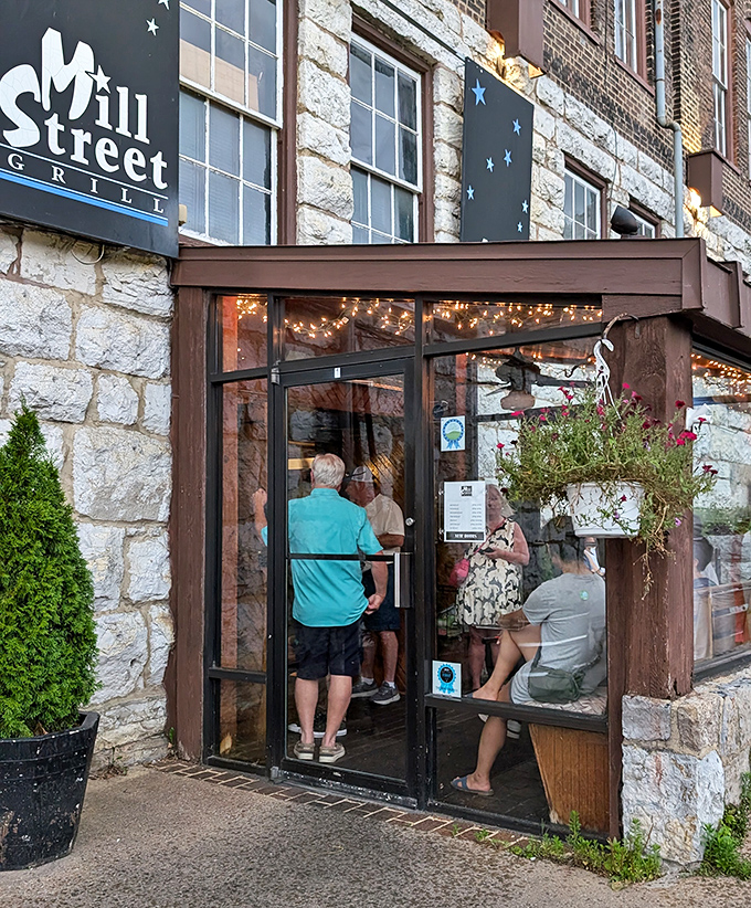 The entrance beckons like a portal to pleasure, with hanging plants and warm lighting suggesting the hospitality that awaits inside.