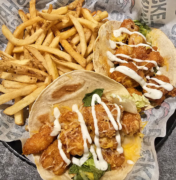 Fish tacos drizzled with sauce that makes you contemplate moving to Pensacola. The kind of casual masterpiece that haunts your food dreams for weeks.