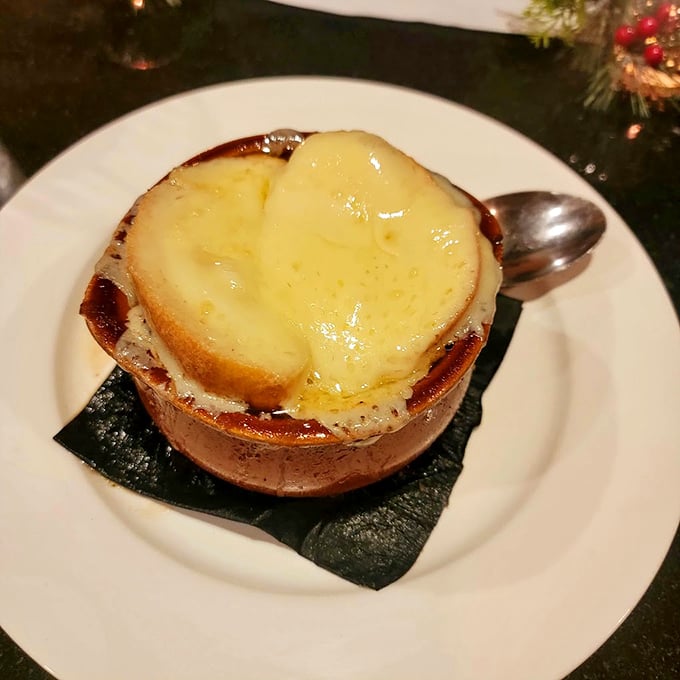 French onion soup wearing its melted cheese beret with pride. A crock of bubbling comfort that's worth the inevitable chin burn.