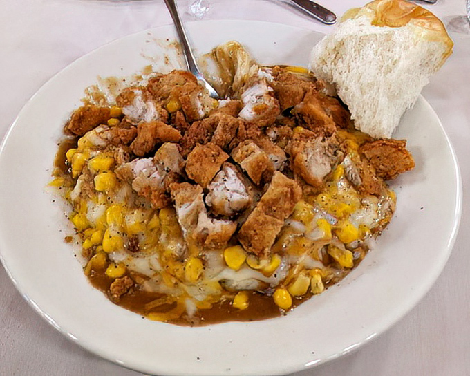 A bowl of comfort featuring fried chicken, corn, and gravy&mdash;proof that sometimes the best dishes are the ones where everything mingles together.