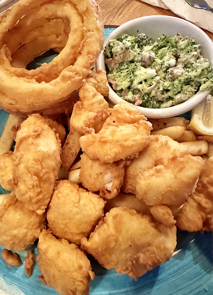 Golden-battered fish bites with crispy onion rings and creamy slaw&mdash;the kind of plate that makes conversation stop as everyone reaches for "just one more."