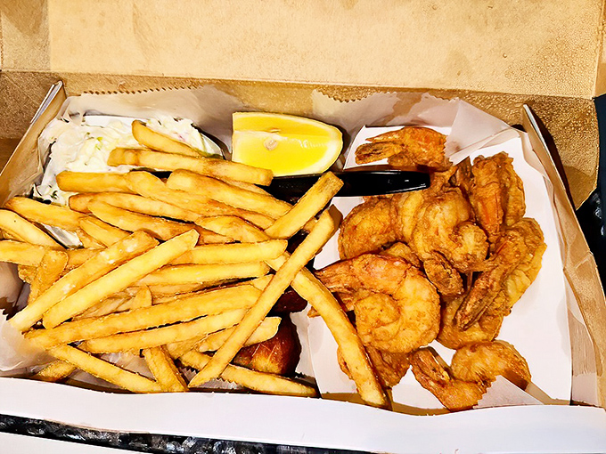 Fried shrimp and fries in a cardboard box—the universal language of seafood happiness. No fancy plating required when it tastes this good.