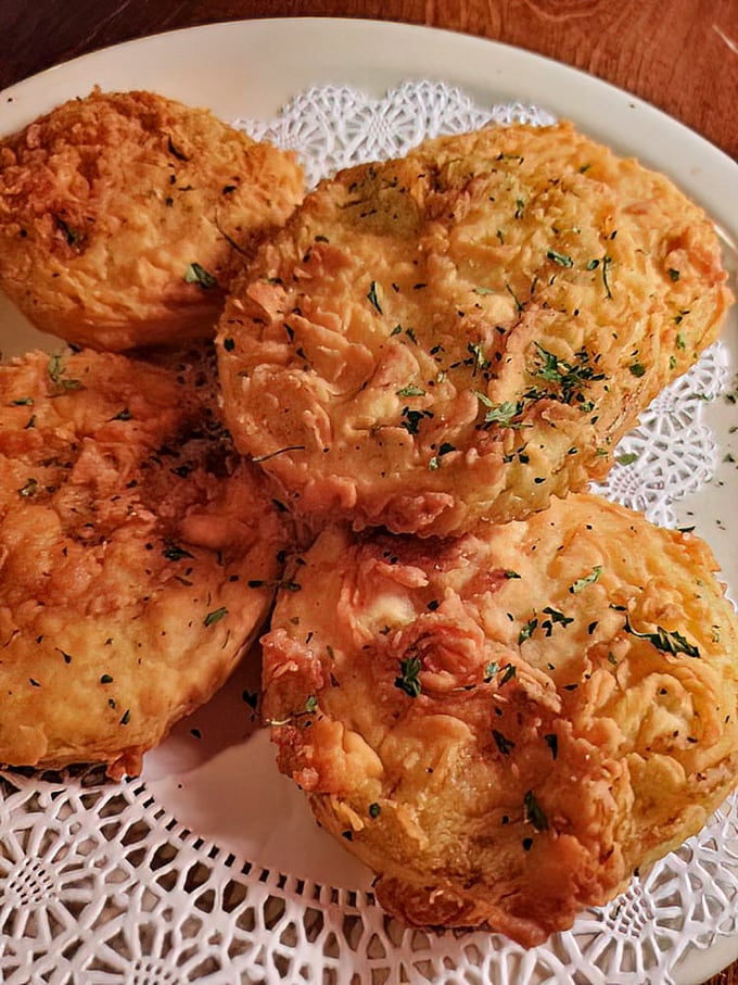 Golden-fried green tomatoes that would make Fannie Flagg proud, served on delicate doilies like the Southern treasures they are.